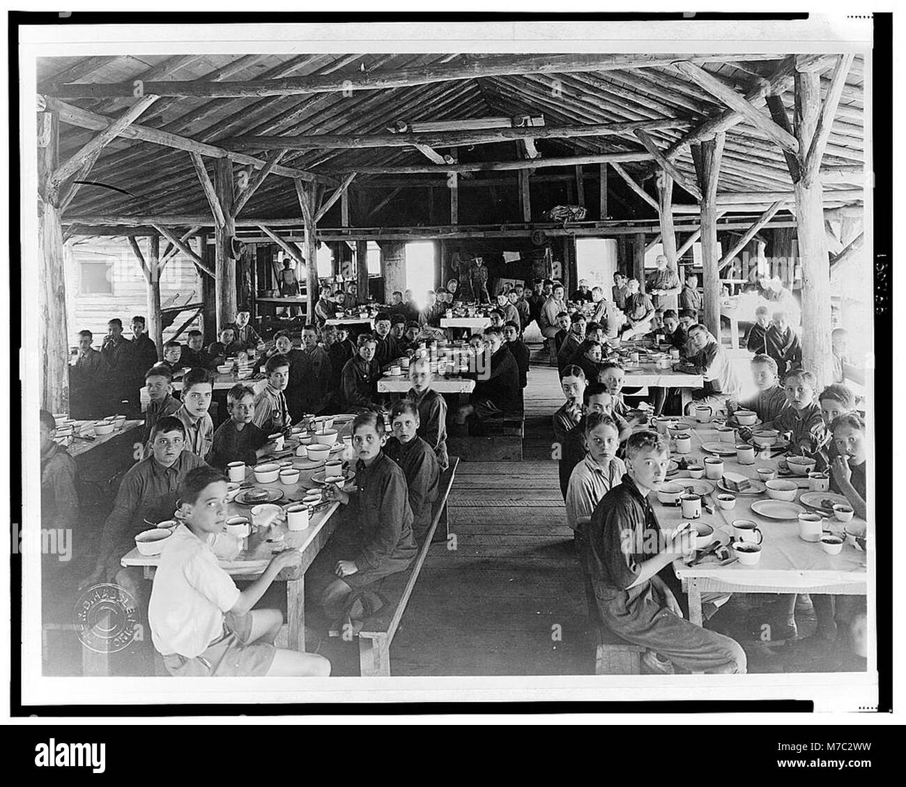 A photo of Boy Scouts eating in the mess hall at Camp Ranachqua ...