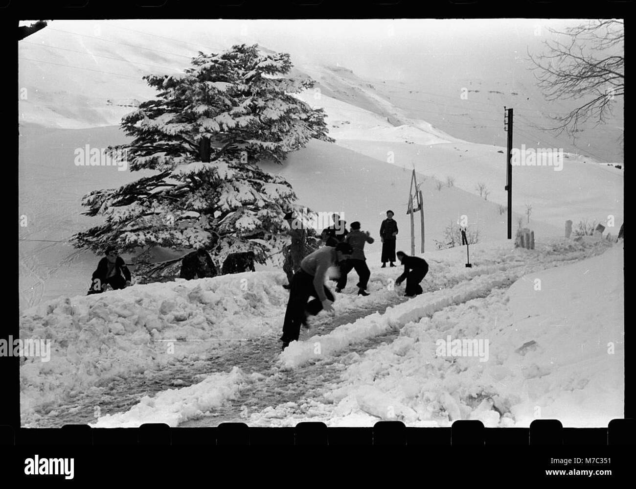 Lebanese soldiers are shown clearing snow from a road, illustrating ...