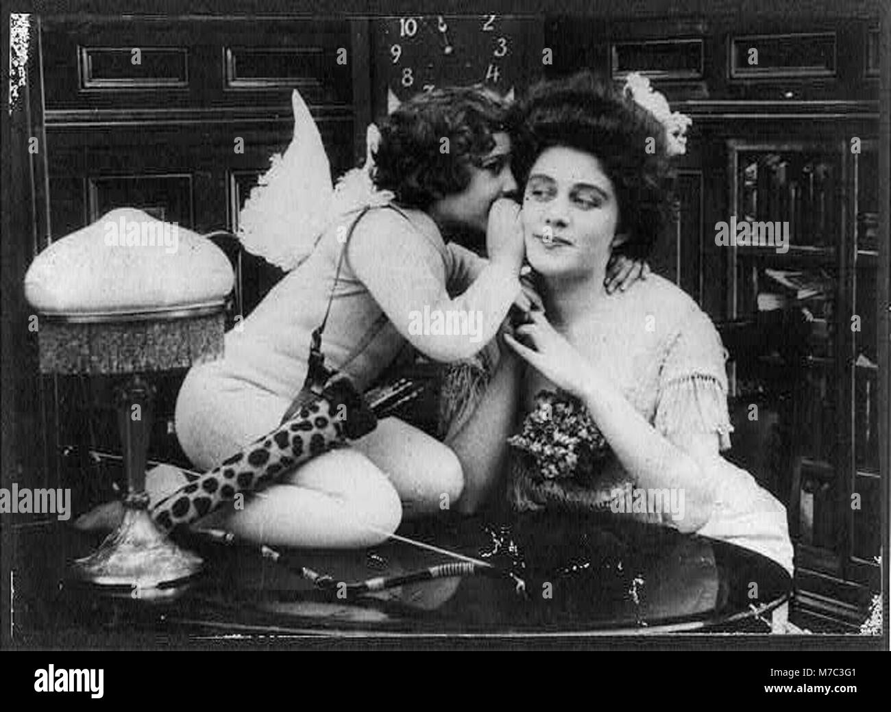 This scene from 'Cupid's Pranks' depicts a playful interaction, likely ...