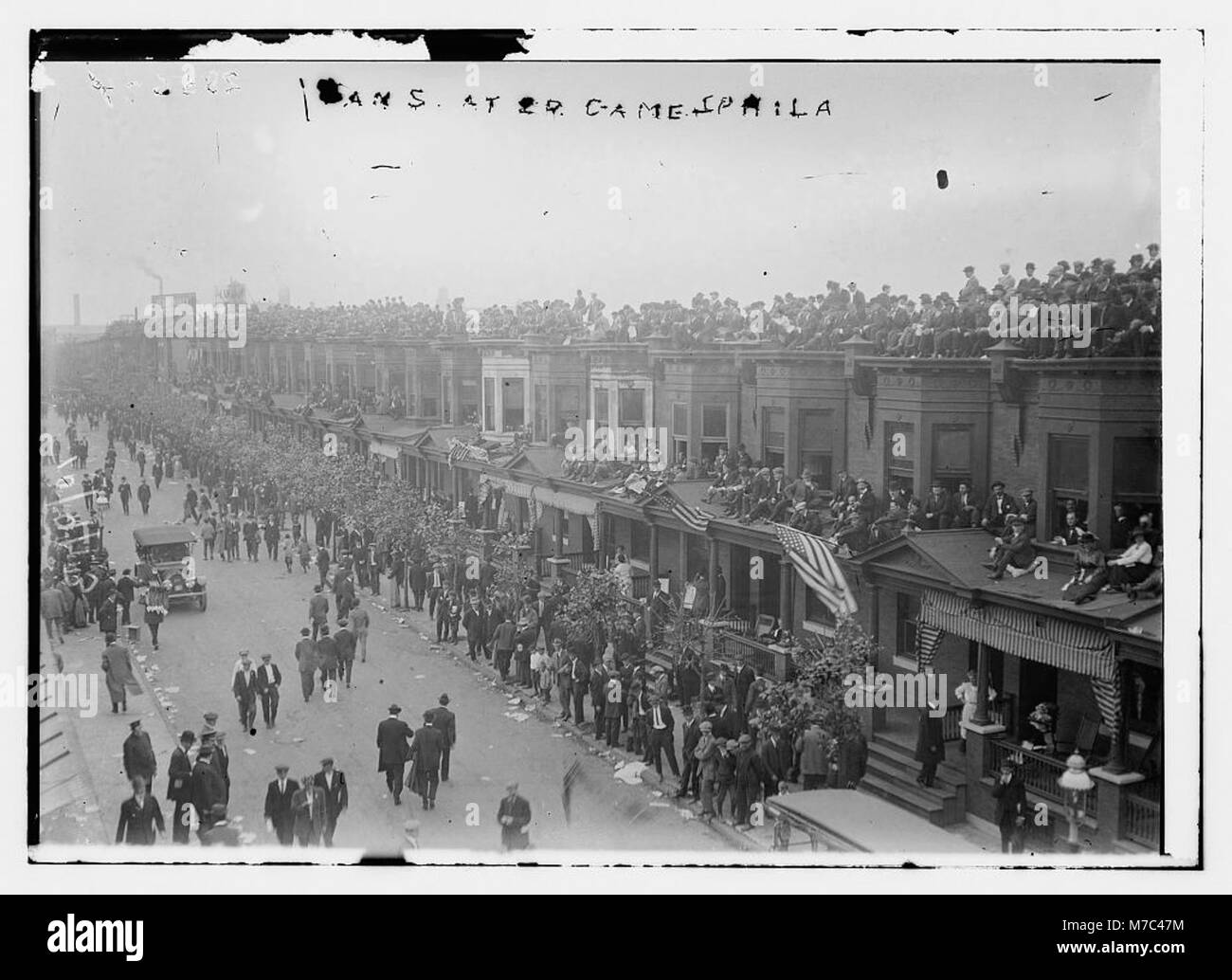 A historic photograph of fans gathered on buildings outside Shibe Park ...