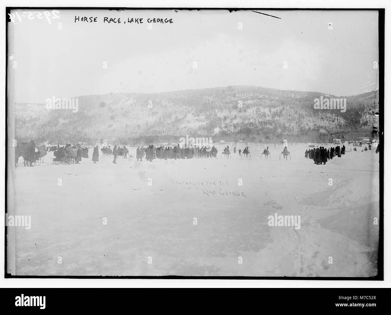 The image captures a horse race at Lake George, an iconic location in ...
