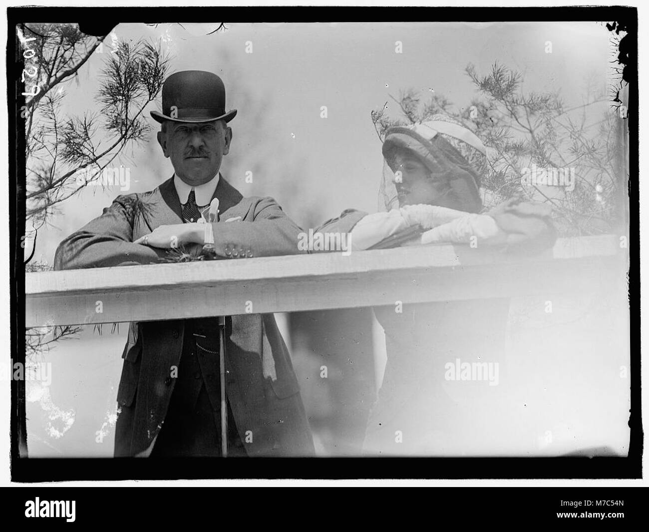 This image shows Mr. J. Low Harriman and Miss Rasmussen at a horse show ...