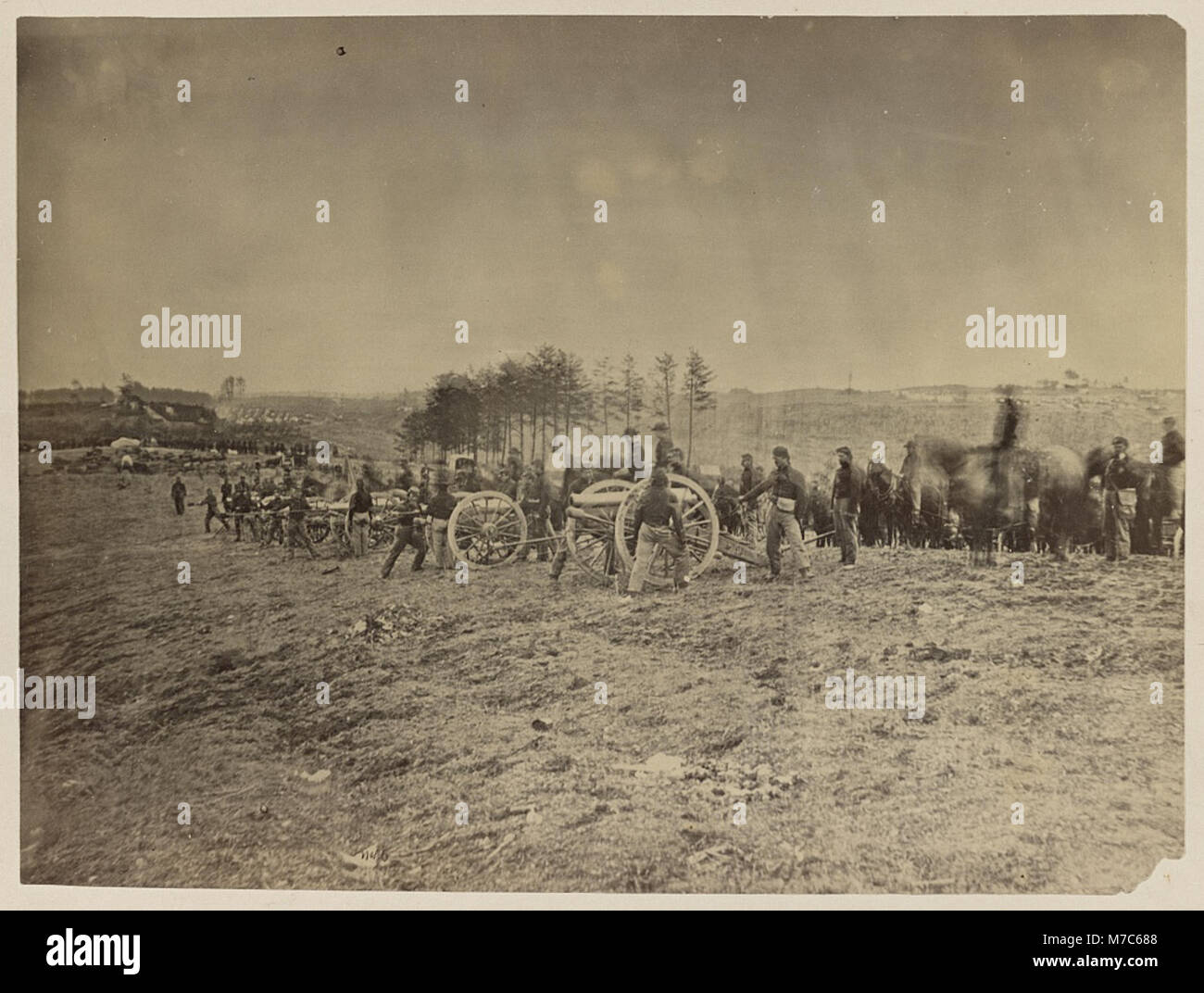 This image depicts soldiers preparing cannons on a battlefield, likely ...