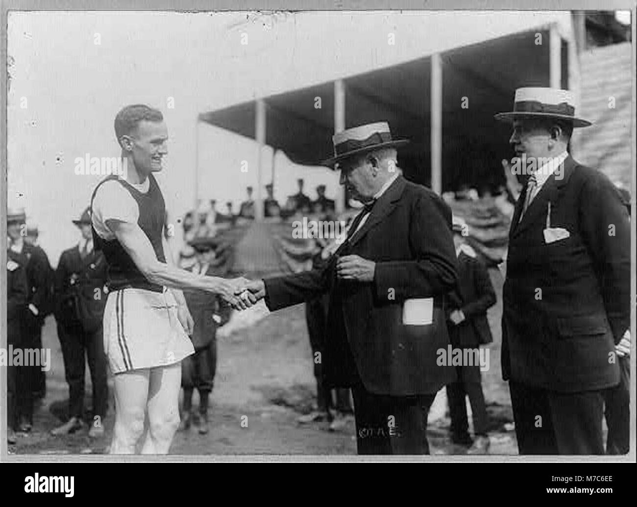 Thomas A. Edison is seen shaking hands with the winner of the Grand ...