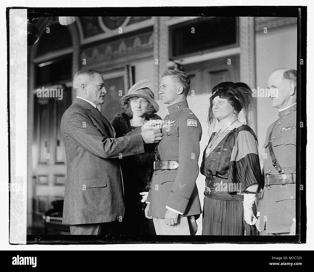 This photograph shows General John J. Pershing decorating Jno. C ...