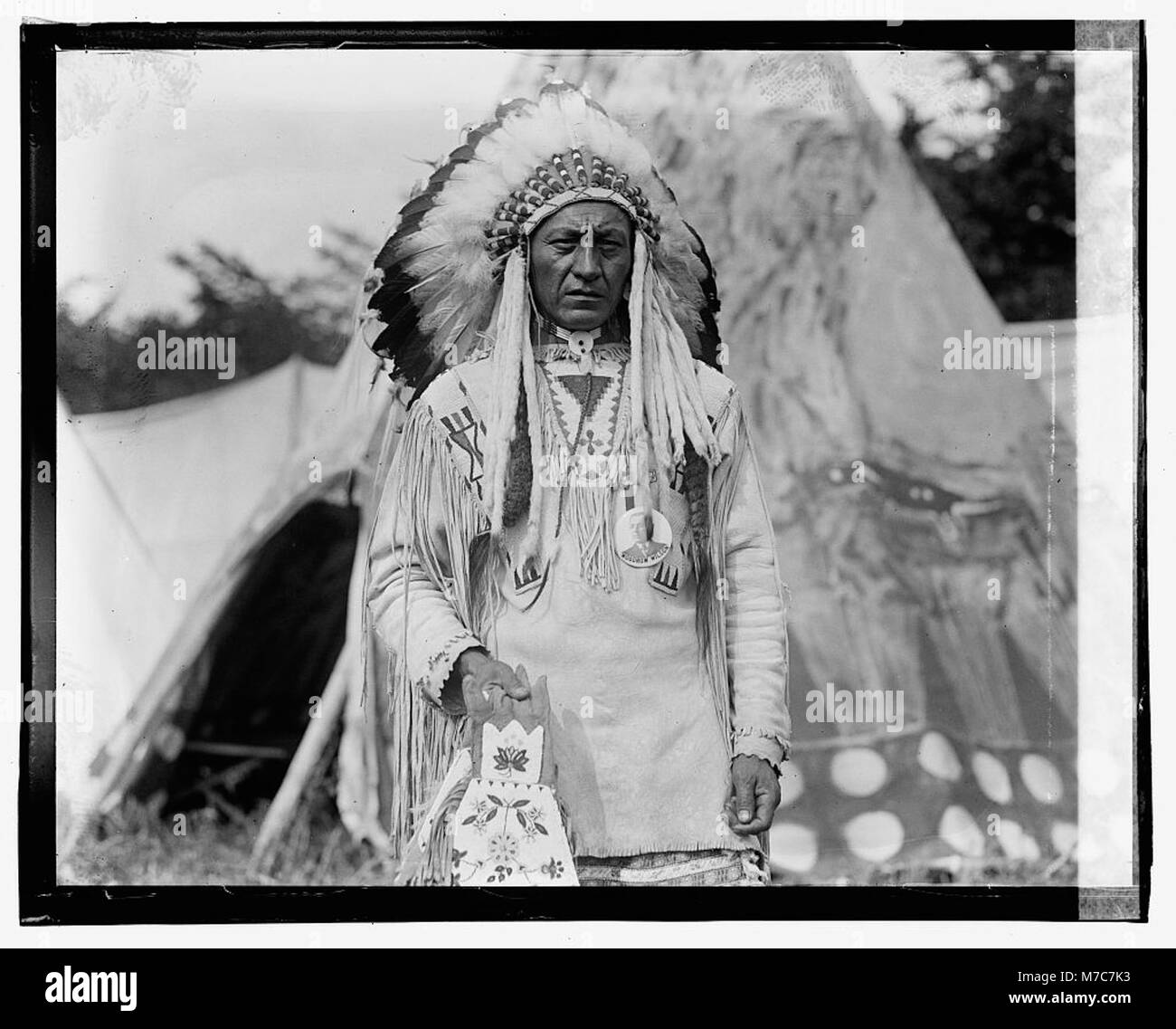 A Native American in traditional clothing captured in a photograph ...