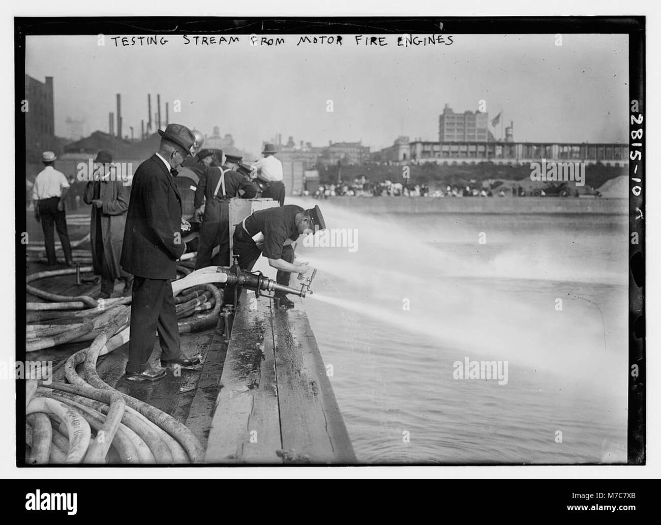 The image depicts the testing of a water stream from motorized fire ...