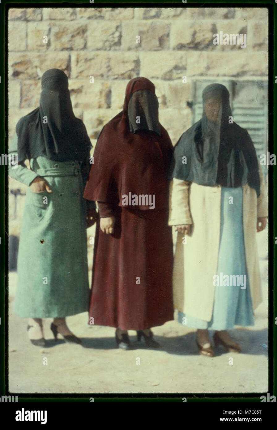 This photograph showcases veiled Muslim women, emphasizing a historical ...