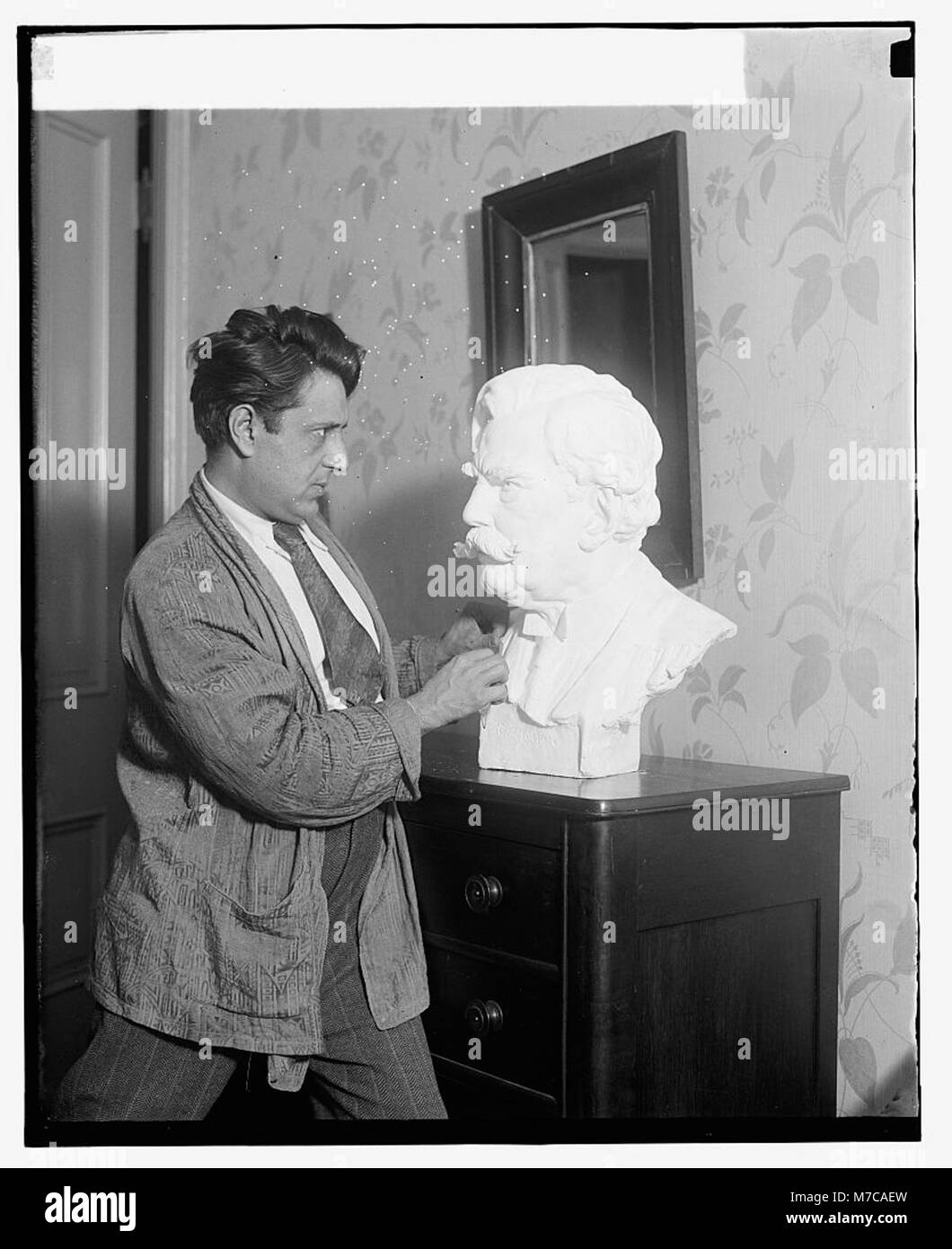 Edgardo Simone is depicted alongside his bust of Justice Holmes ...