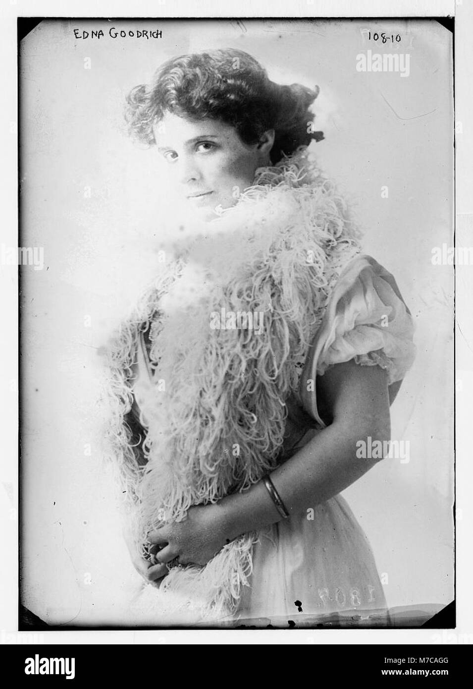 A portrait of Edna Goodrich standing in a three-quarters pose ...