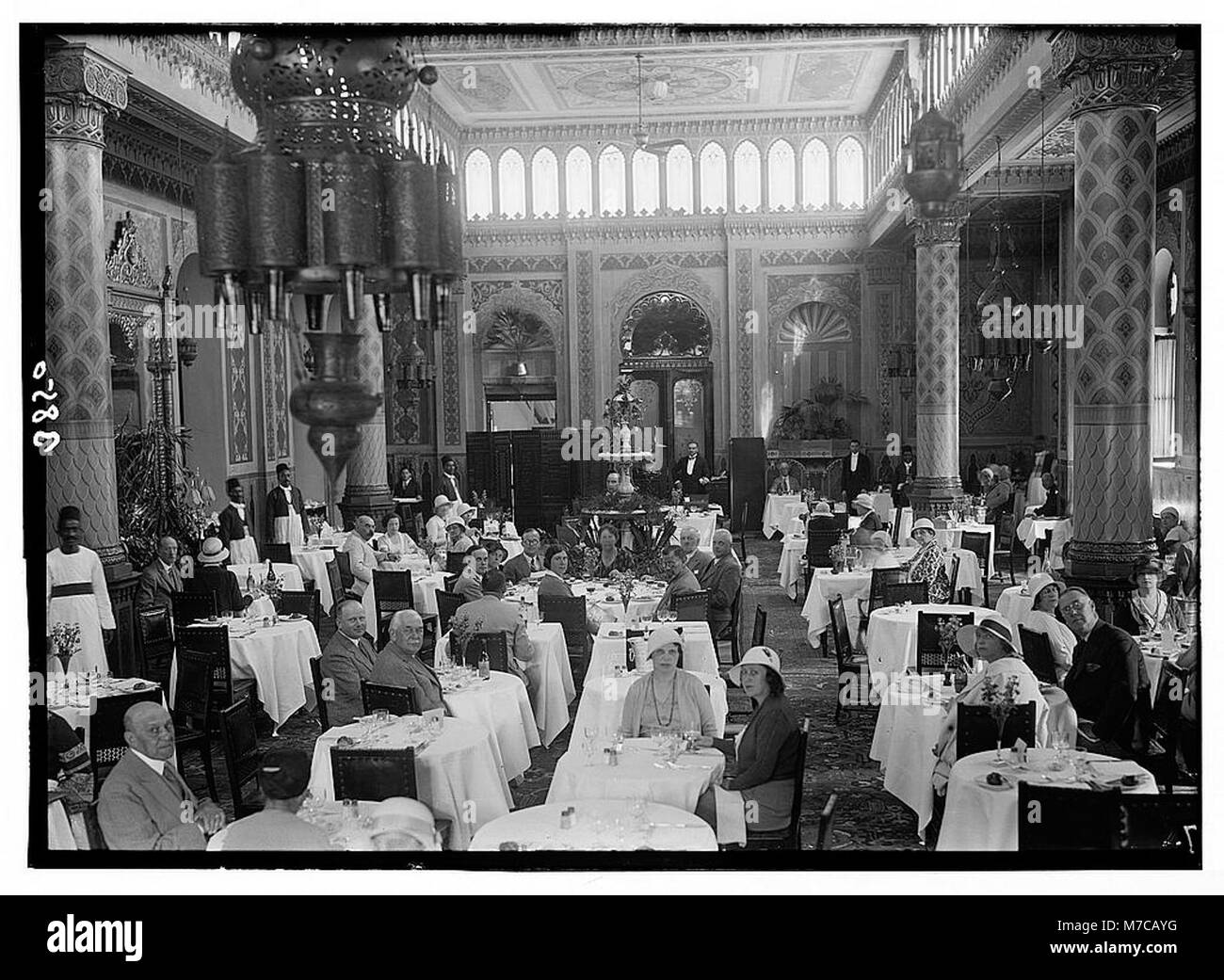 An interior view of the main dining hall at Shepheard's Hotel in Cairo ...