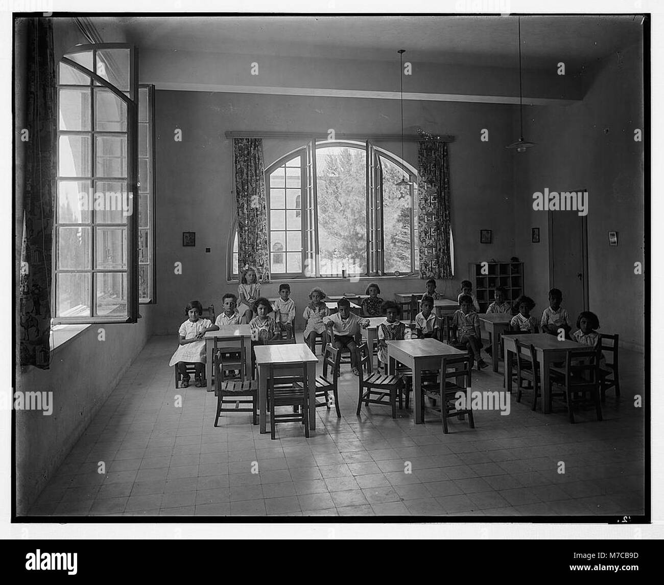 An image of a typical early 20th-century elementary schoolroom. The ...