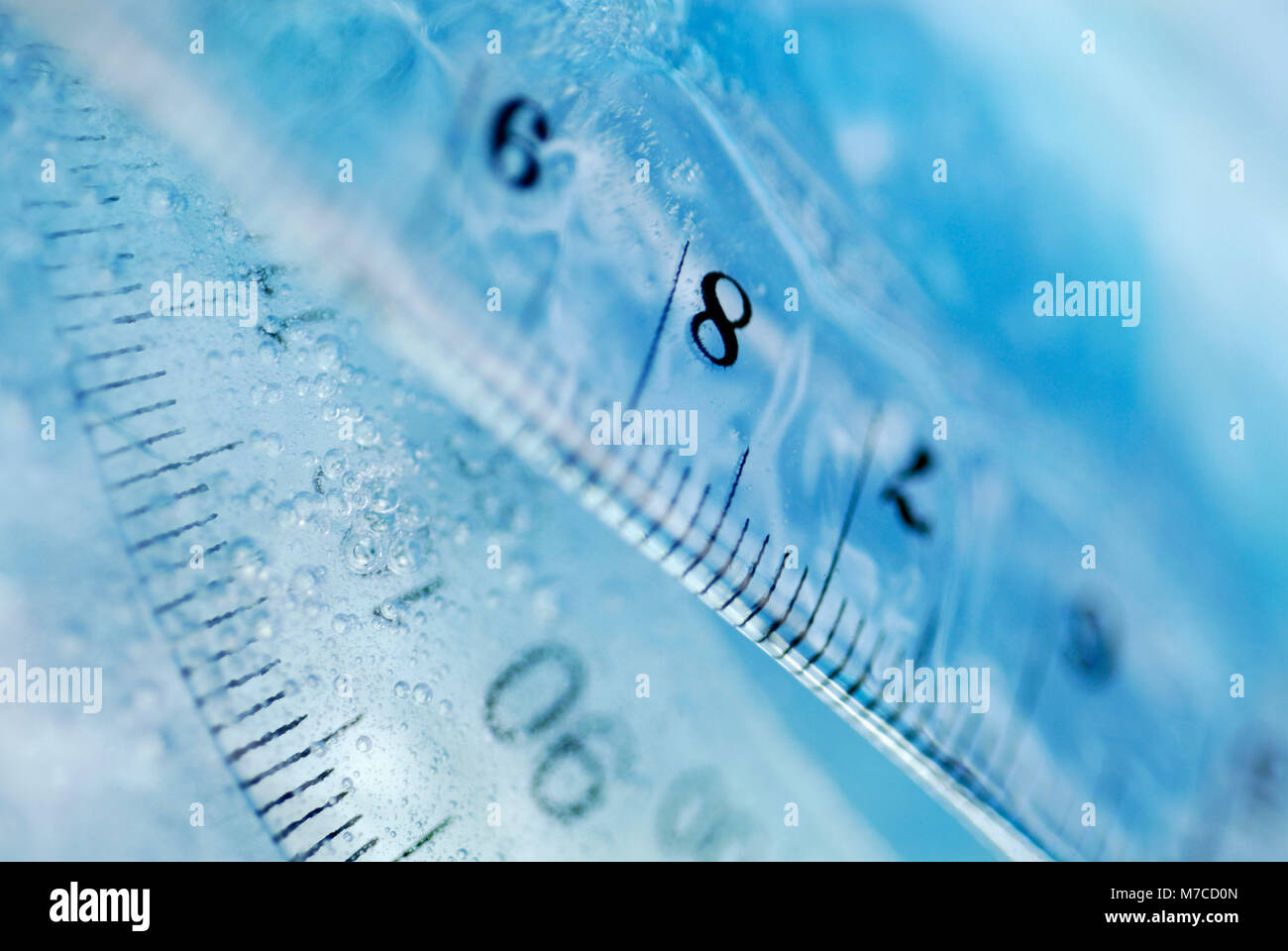 Close-up of a protractor and a ruler in water Stock Photo - Alamy