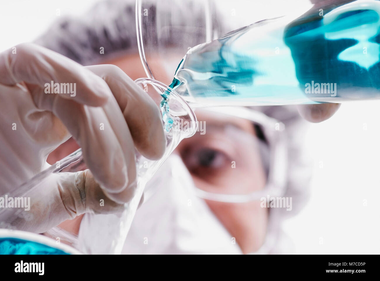 Mixed race scientist holding beaker hi-res stock photography and images ...