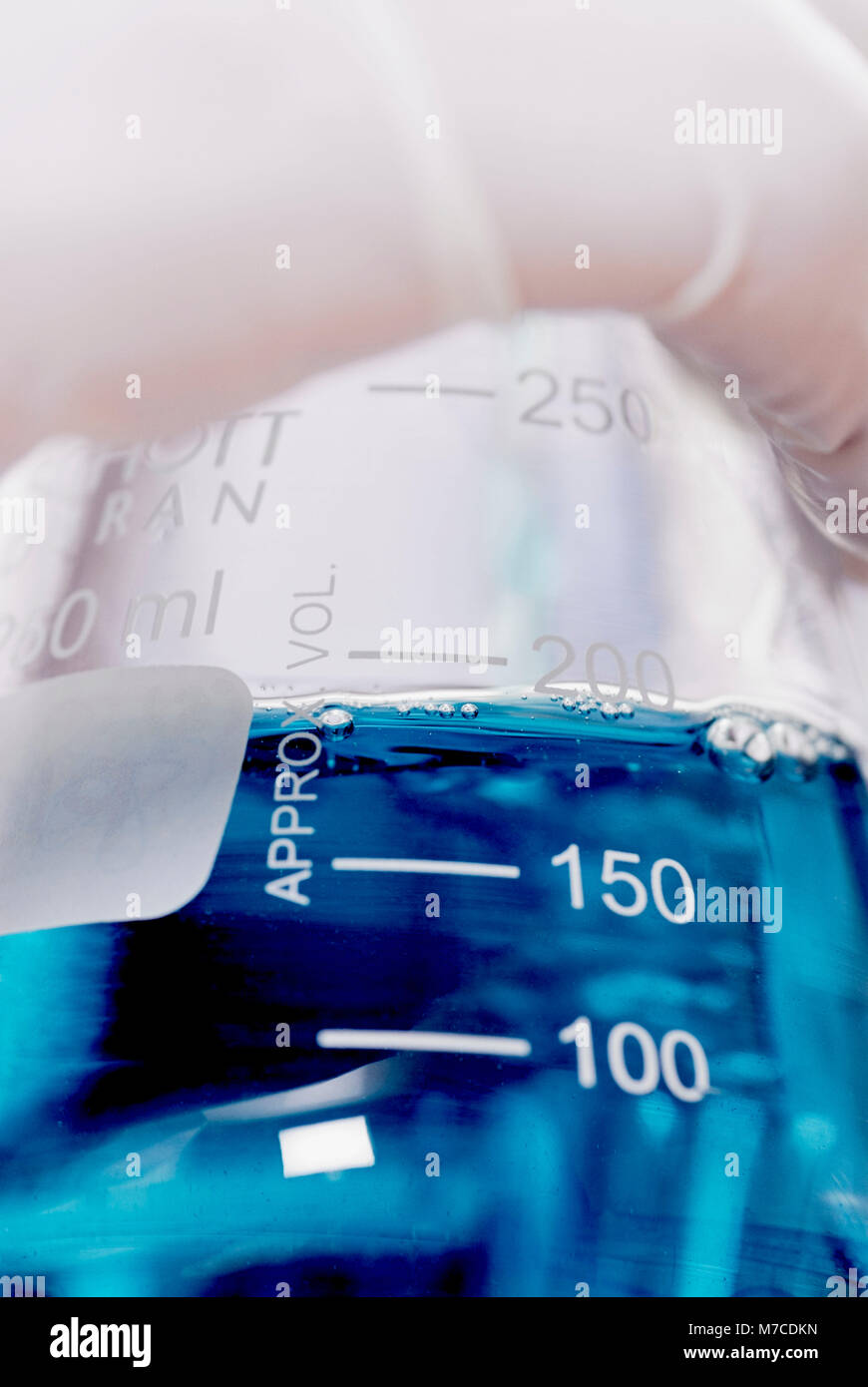 Close-up of a person's hand holding a conical flask Stock Photo - Alamy