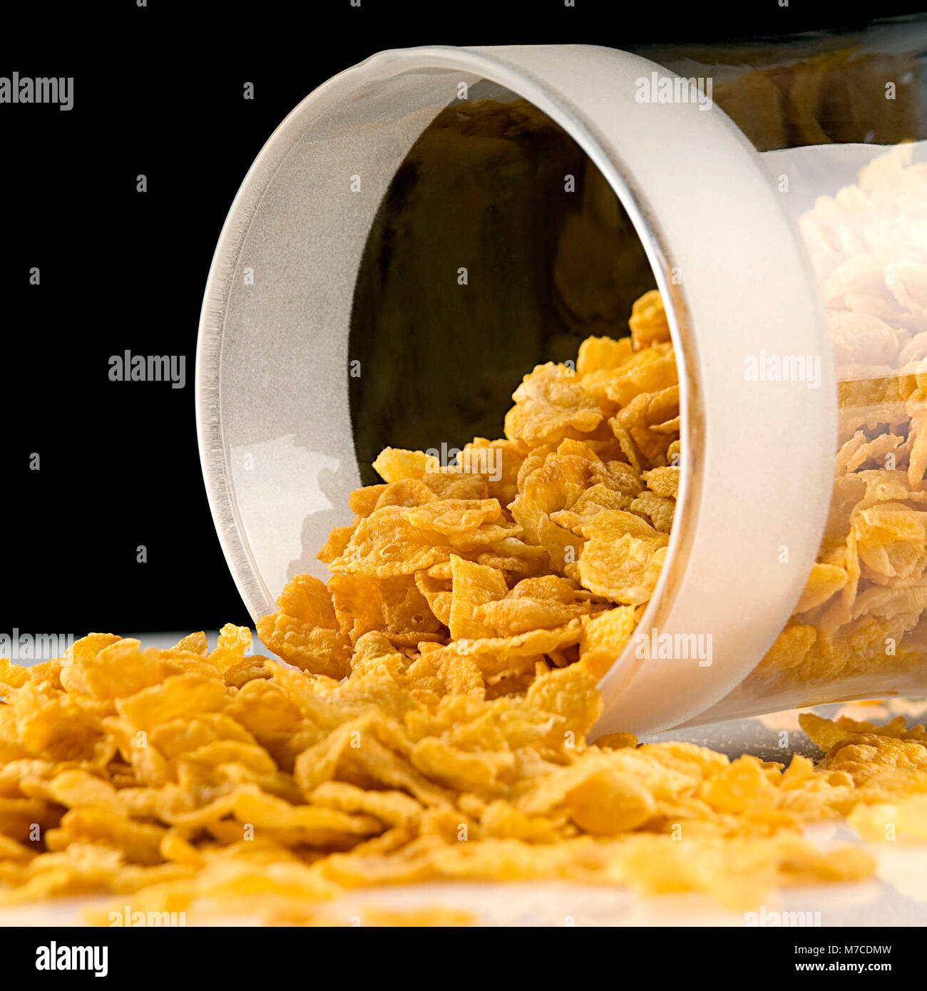 Close-up of a spilled jar of corn flakes Stock Photo - Alamy