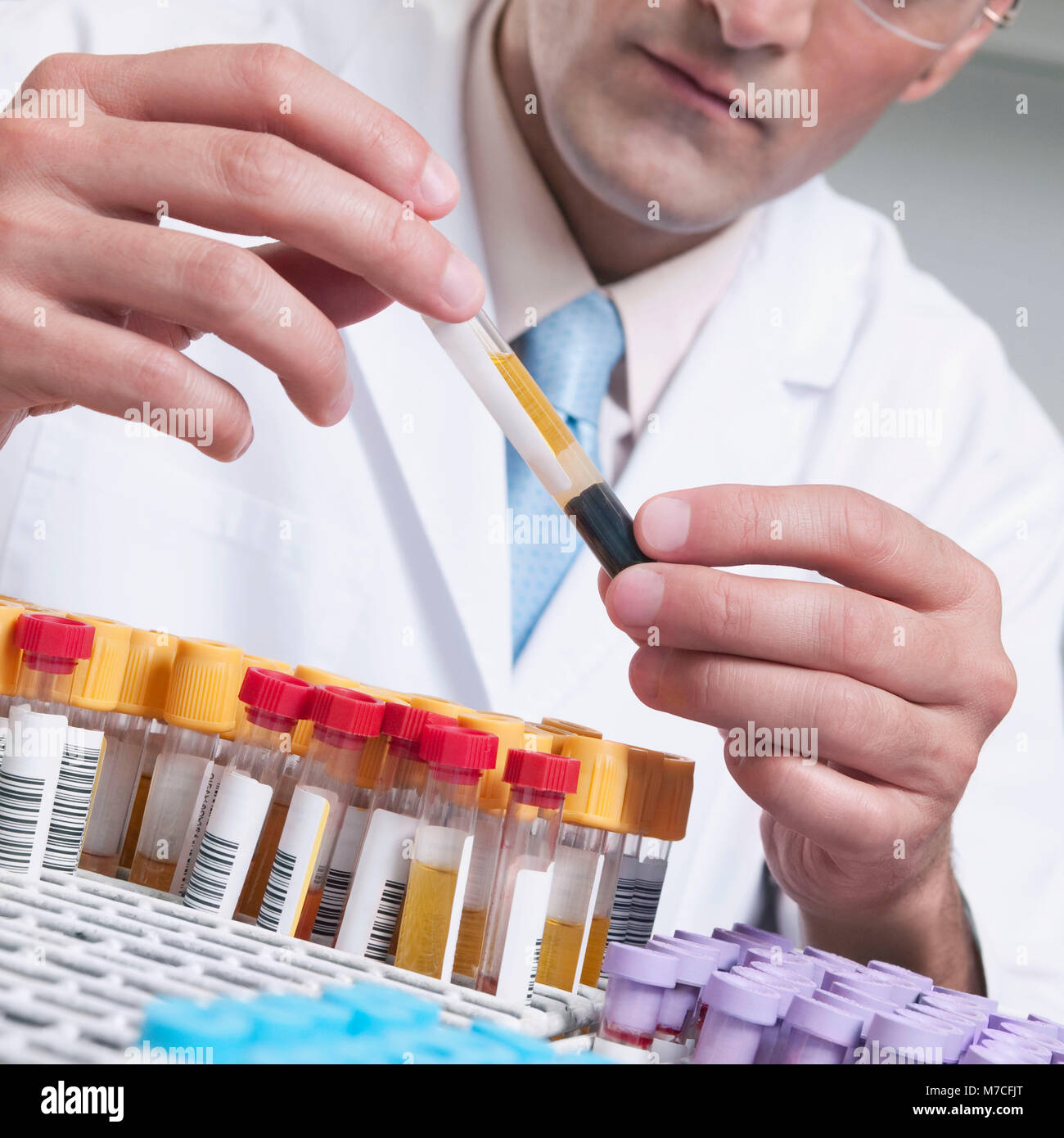 Lab technician analyzing sample in a test tube Stock Photo - Alamy