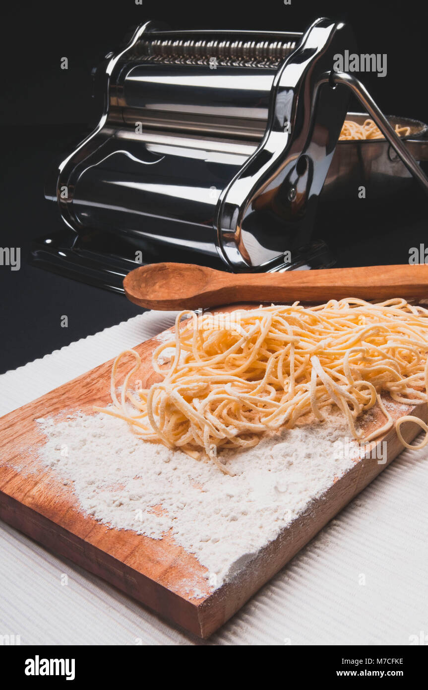 Close-up of spaghetti with a pasta maker Stock Photo - Alamy