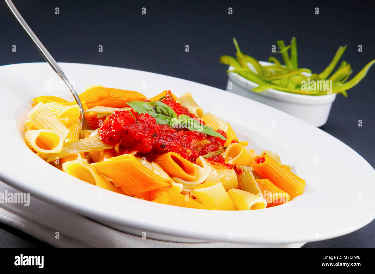 Dish of rigatoni pasta topped with tomato concasse Stock Photo - Alamy