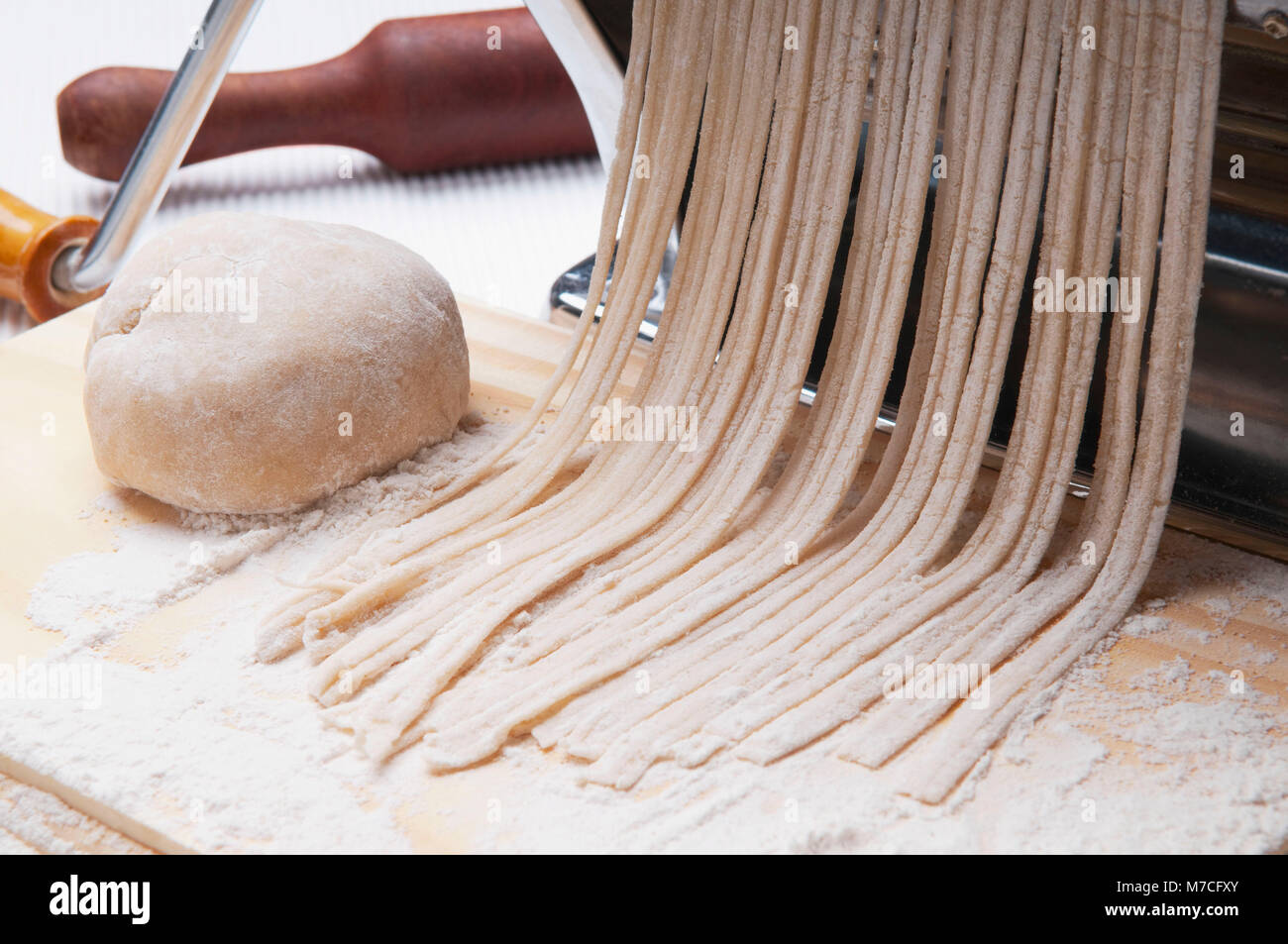 Pasta maker making spaghetti Stock Photo - Alamy