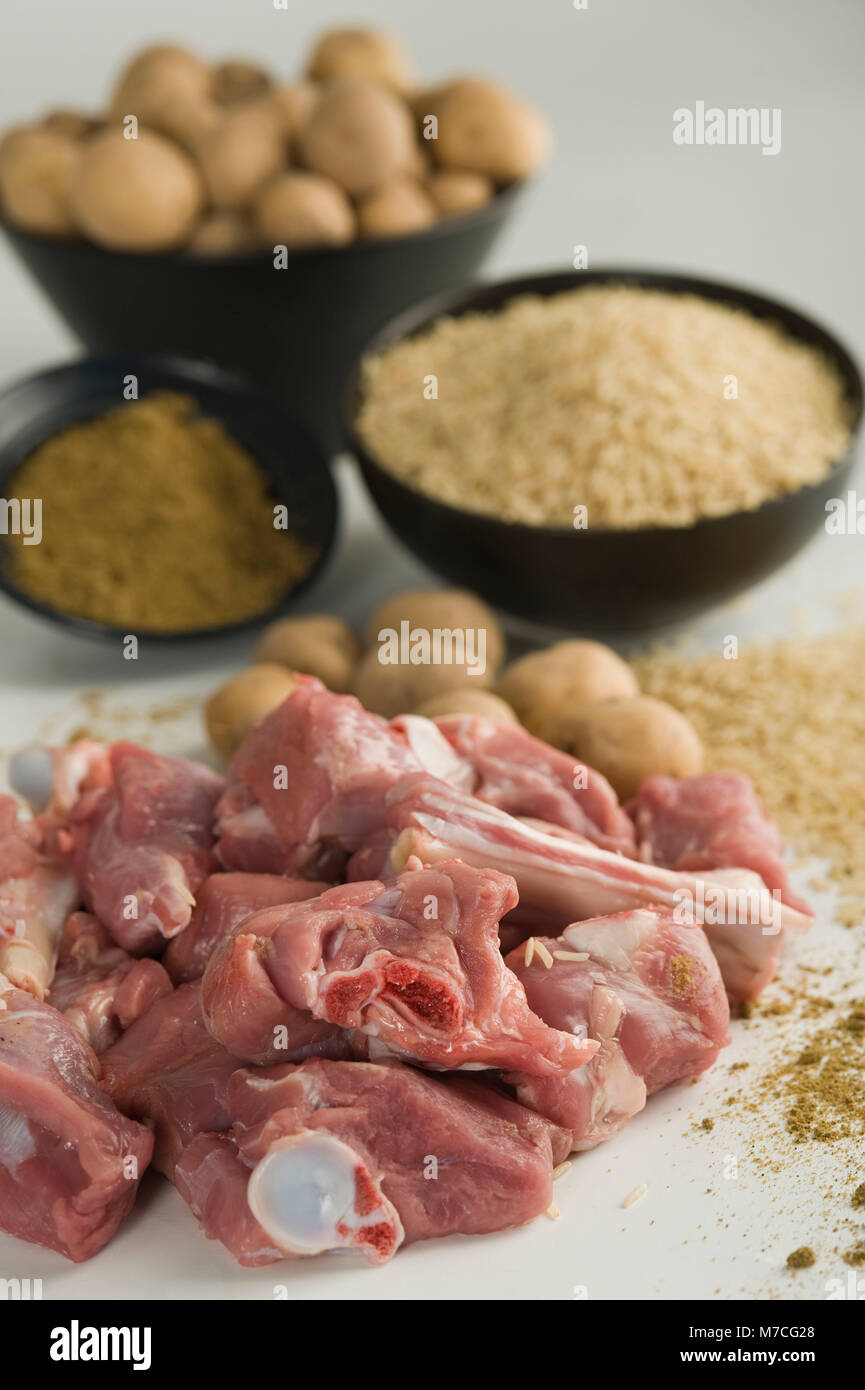 Close-up of mutton with raw potatoes and rice Stock Photo - Alamy