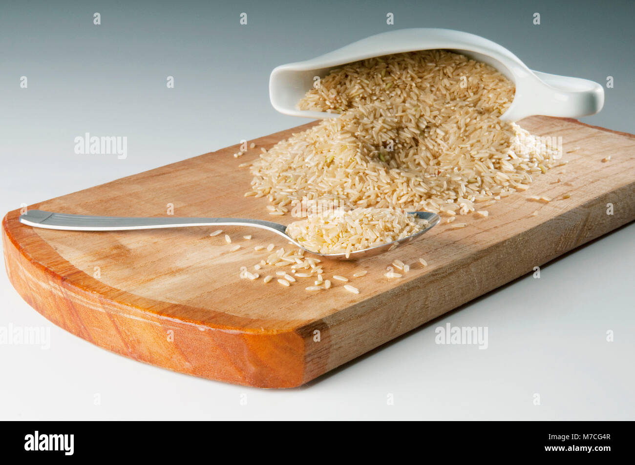 Close-up of brown rice spilling from a ceramic jug Stock Photo - Alamy