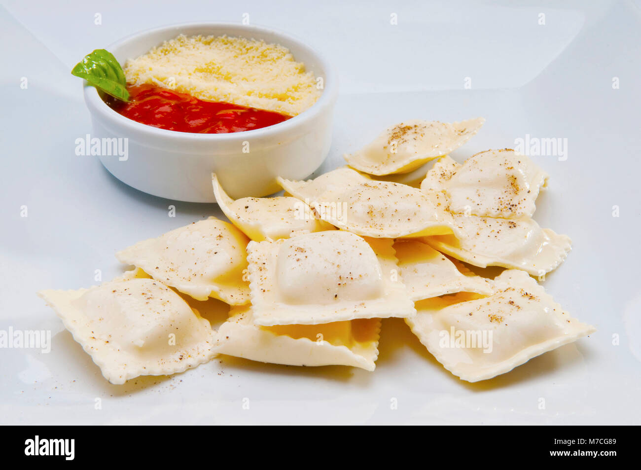 High angle view of ravioli served with tomato sauce and grated cheese ...