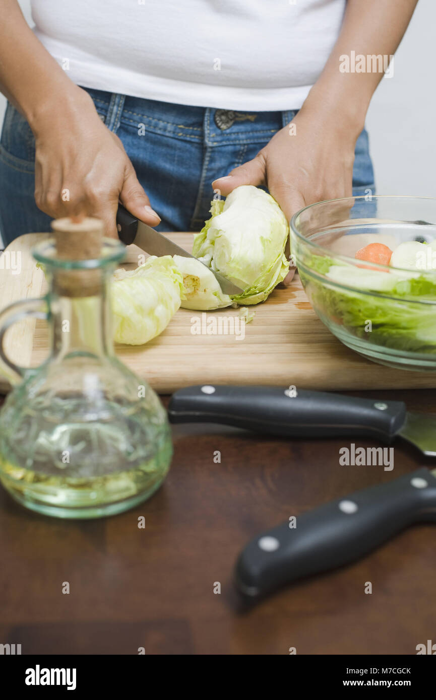 Mid section view of a woman chopping lettuce Stock Photo - Alamy