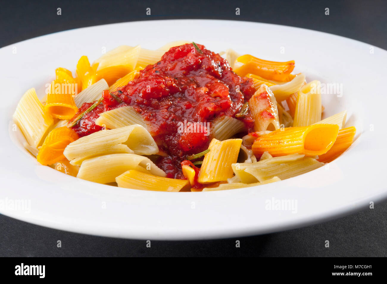 Dish of rigatoni pasta topped with tomato concasse Stock Photo - Alamy