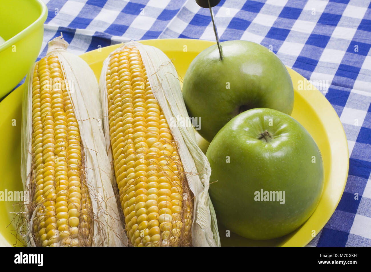 Close-up of corn on the cob with green apples Stock Photo - Alamy