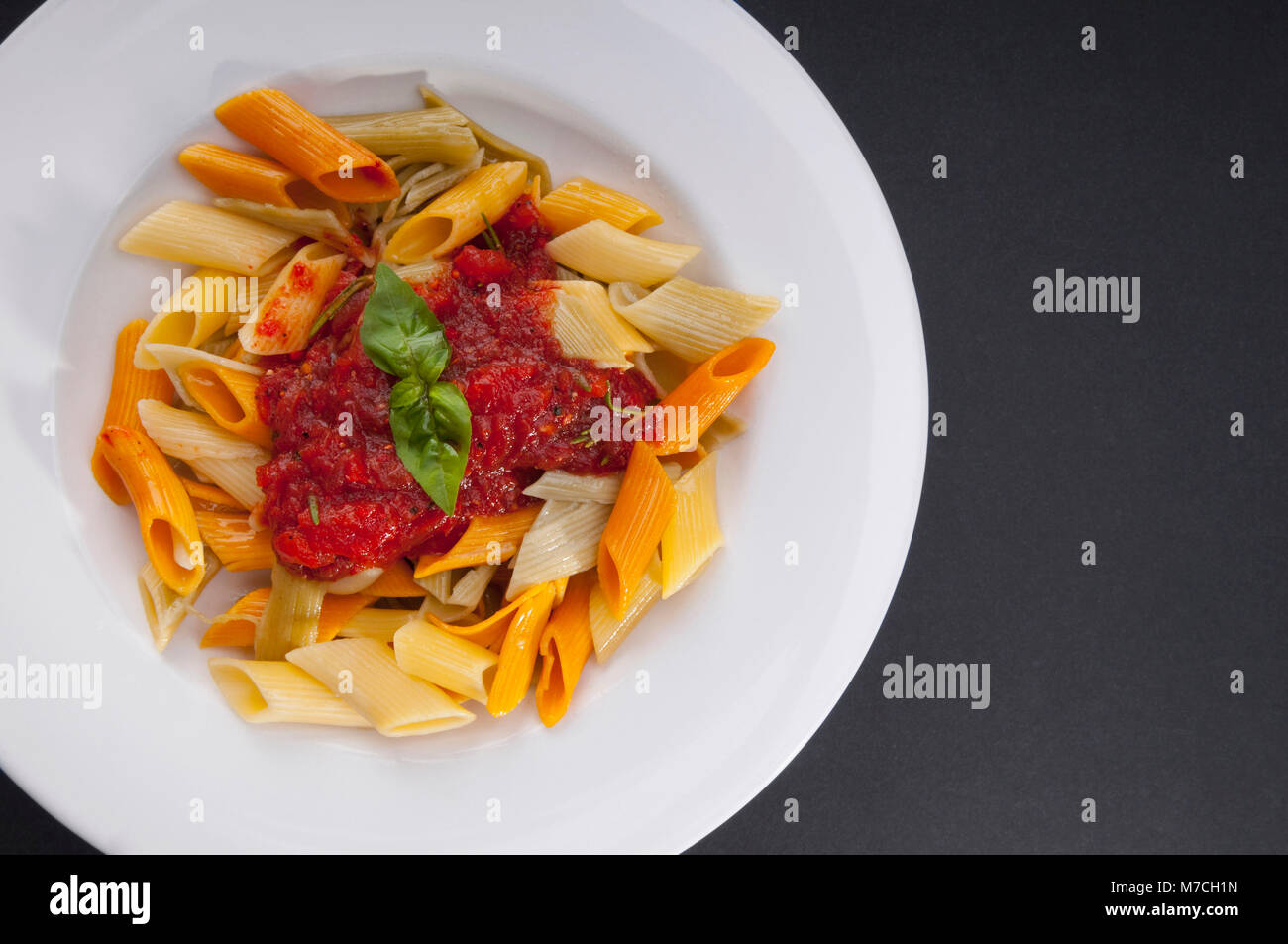 High angle view of rigatoni pasta topped with tomato concasse Stock ...
