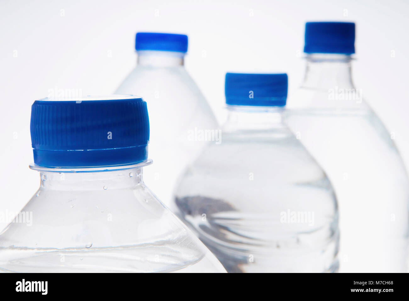 Close-up of four bottles of water Stock Photo - Alamy