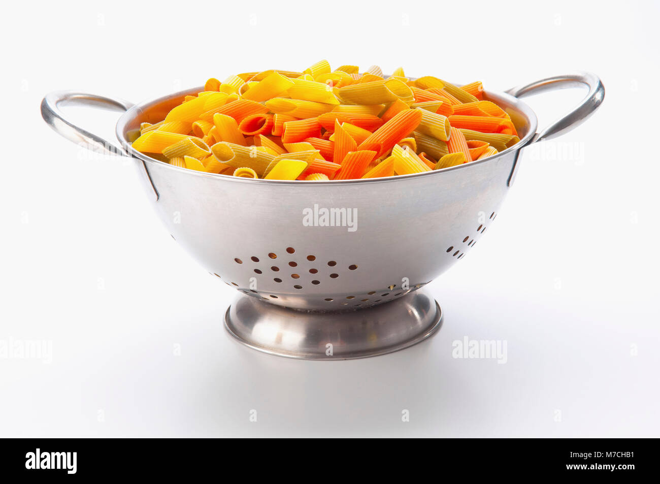 Multi colored rigatoni pasta in a strainer Stock Photo - Alamy
