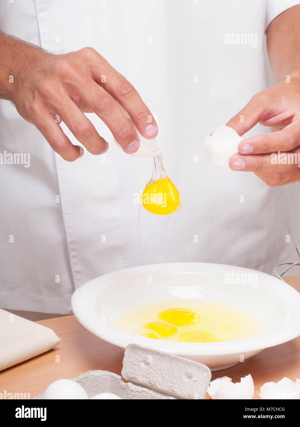 Man breaking eggs in a bowl Stock Photo - Alamy