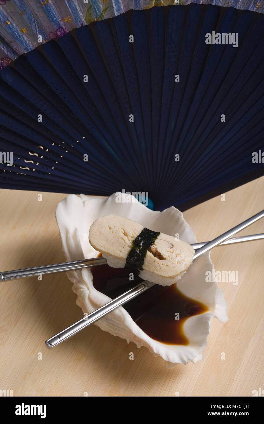 Close-up of a nigiri sushi with a folding fan Stock Photo - Alamy