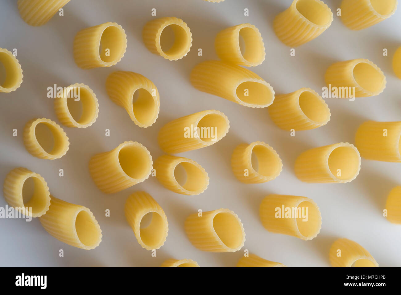 Close up of raw rigatoni on a white background hi-res stock photography ...