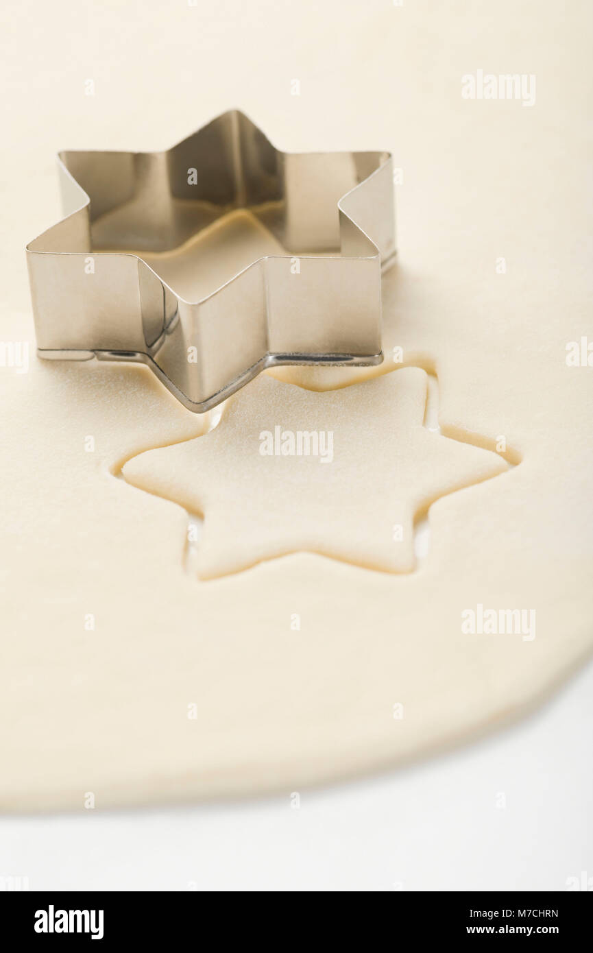 Star shape pastry cutter on dough Stock Photo - Alamy