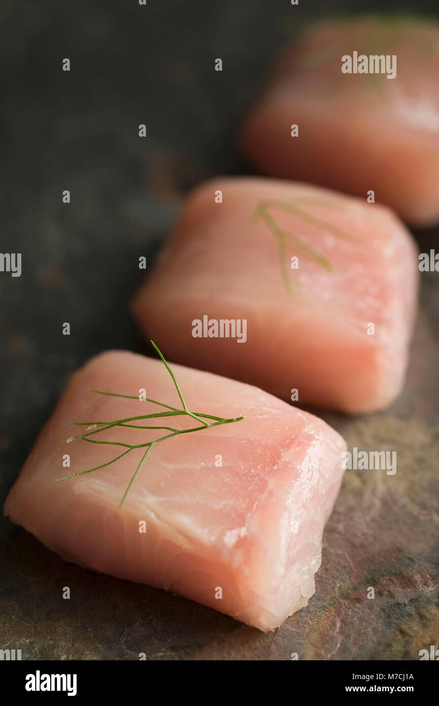Close-up of slices of fish with herbs Stock Photo - Alamy