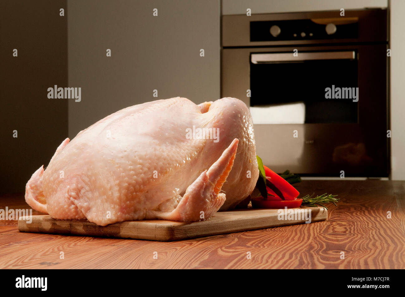 Close-up of an uncooked turkey on a chopping board Stock Photo - Alamy