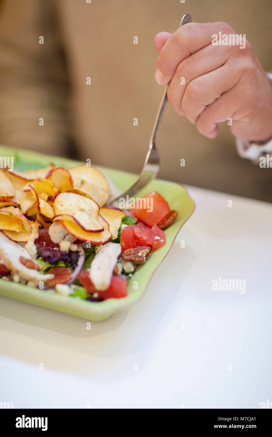 Mid section view of a man eating salad Stock Photo - Alamy