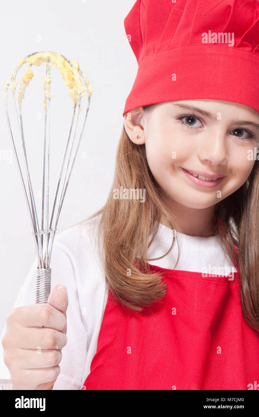 Portrait of a girl holding a wire whisk Stock Photo - Alamy