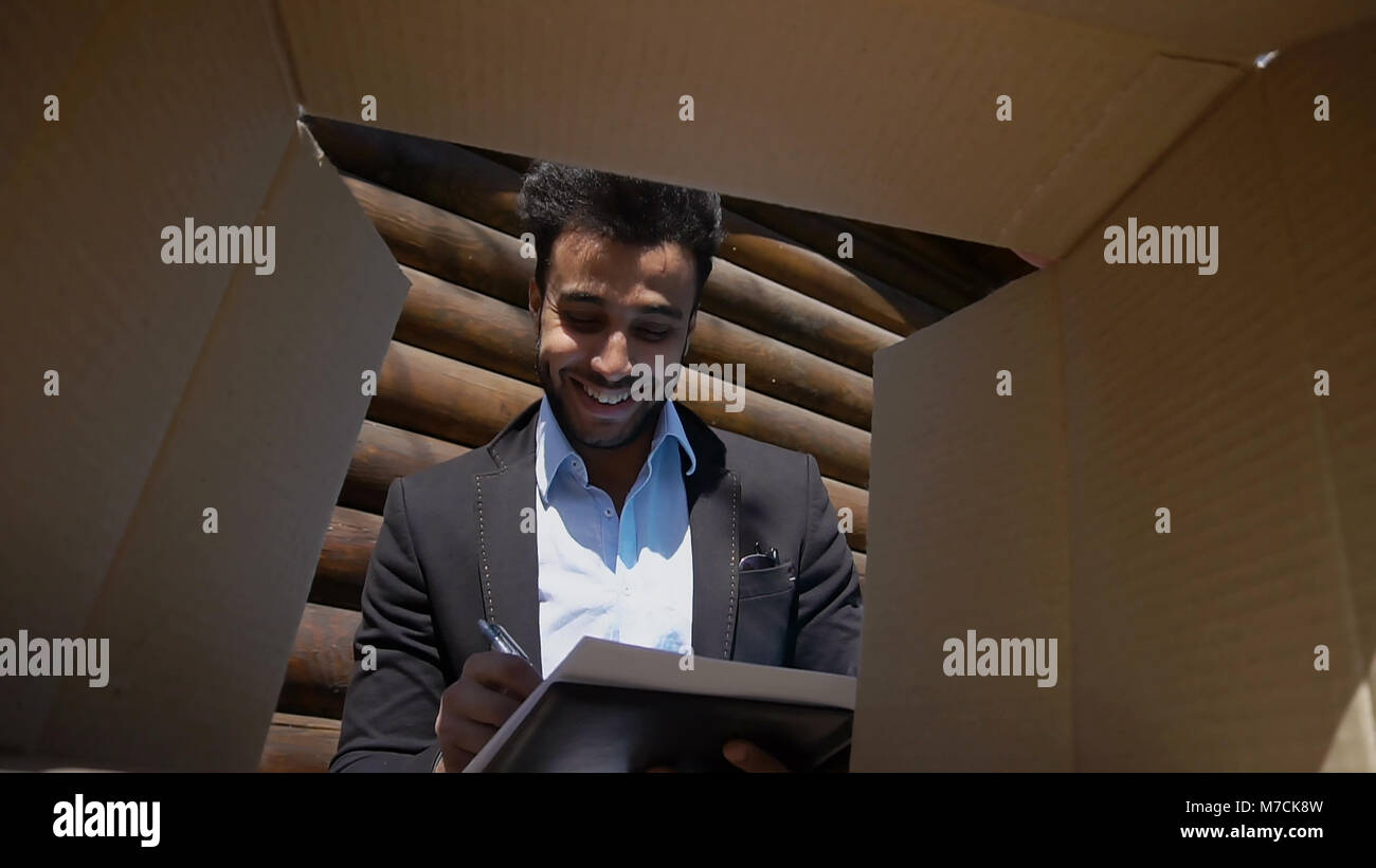 Boy signs for package and smiling Stock Photo - Alamy