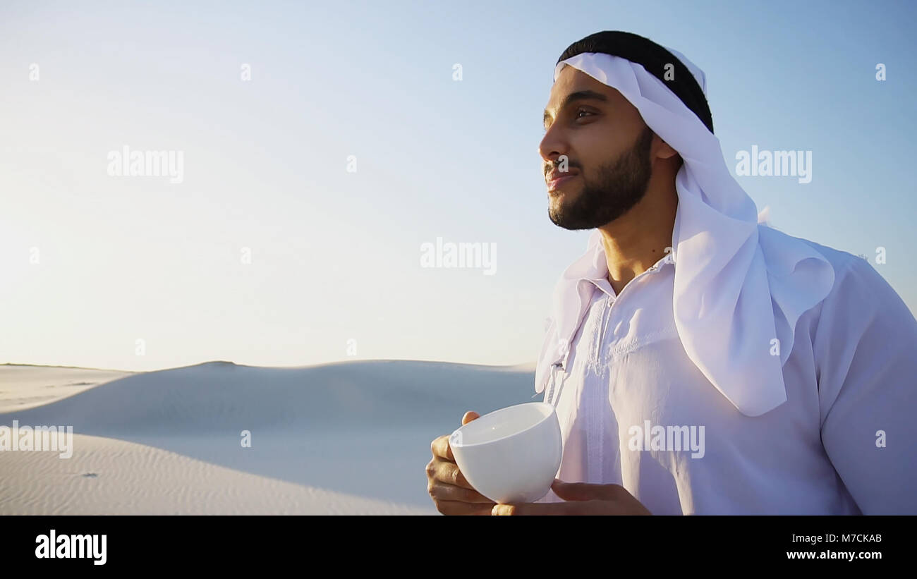 Good morning for male sheikh in middle of huge desert over cup o Stock ...