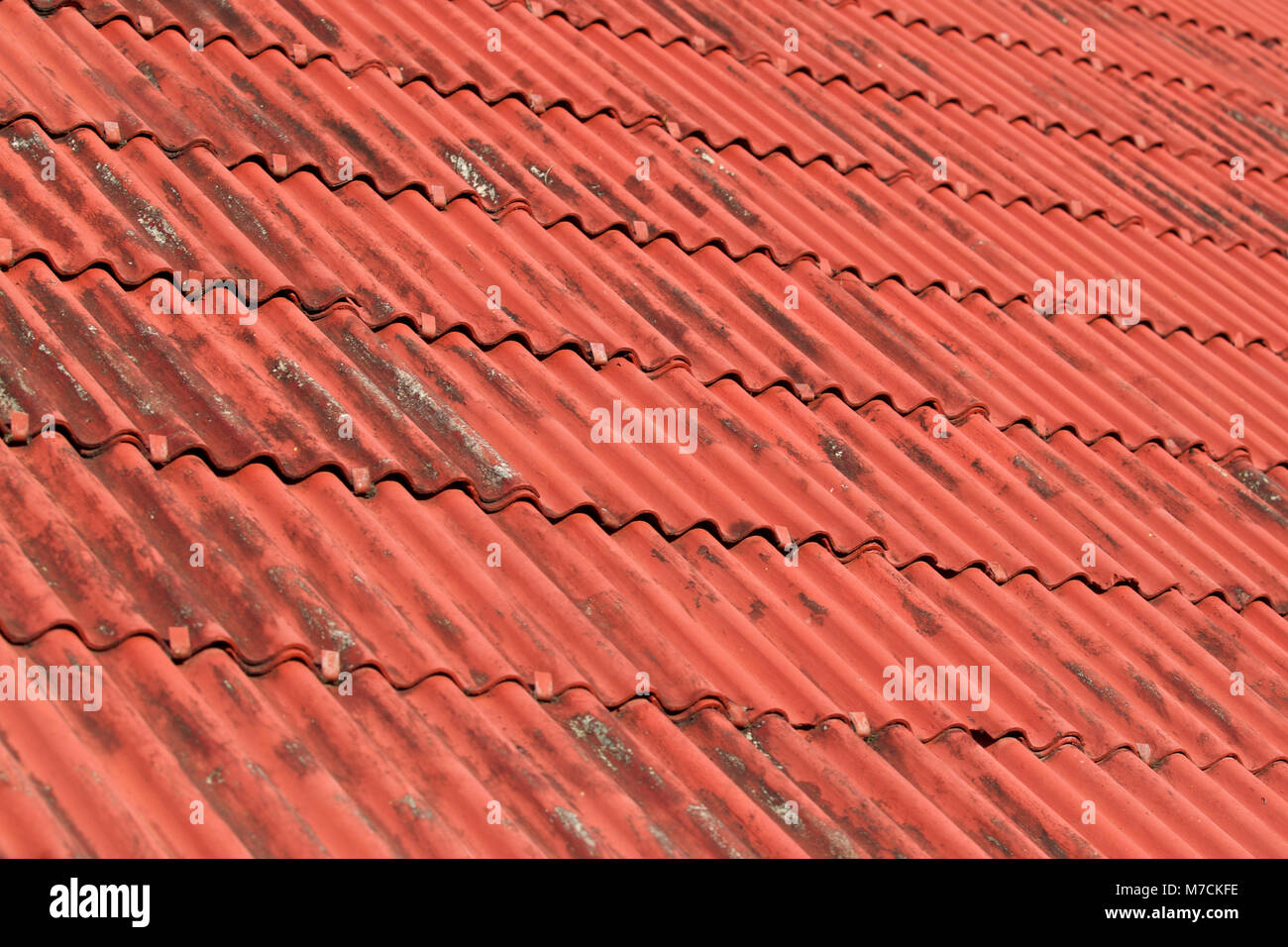 Overlapping the roof with undulating sheet material such as slate Stock ...