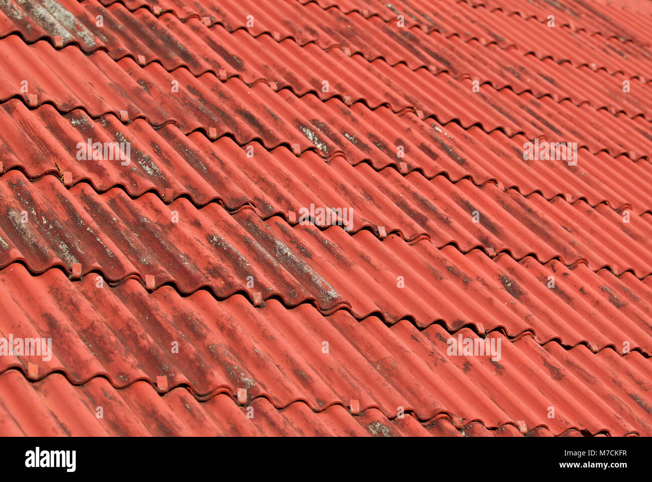 Overlapping the roof with undulating sheet material such as slate Stock ...