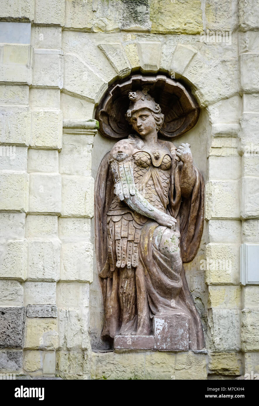 God statue on the stone wall at ancient castle in Saint Petersburg ...