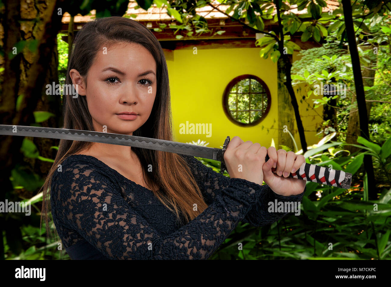 Young woman with a samurai bushido katana sword Stock Photo - Alamy