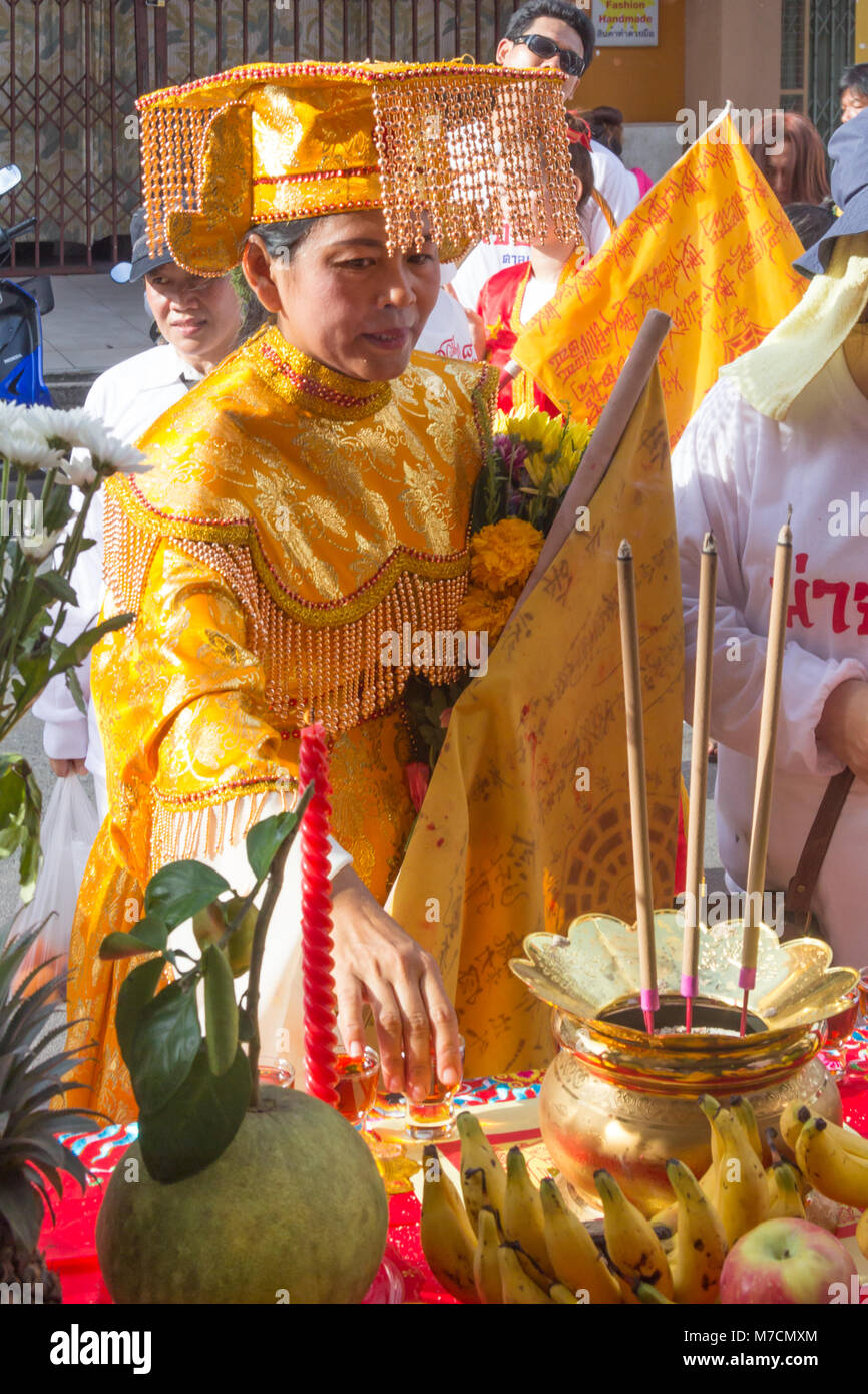 Woman spirit medium blessing offerings during a parade during the Nine ...
