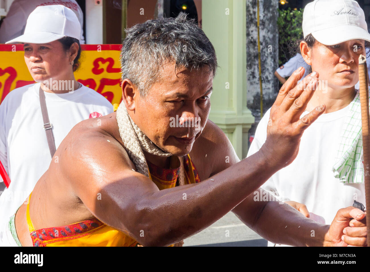 A male spirit medium gives a blessing in a parade during the Nine ...