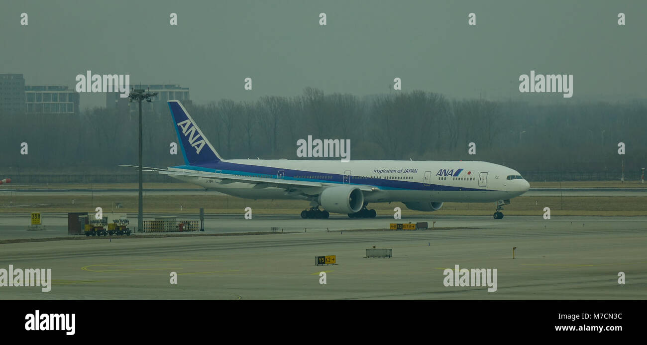 Beijing, China - Feb 17, 2018. An ANA aircraft on runway at Terminal 3 ...